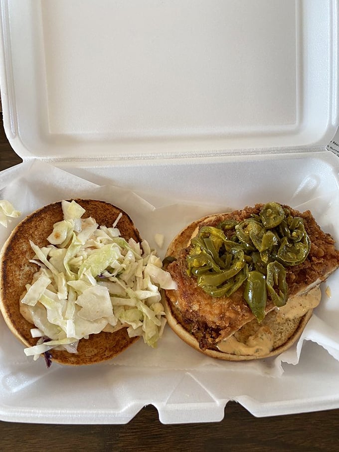 Two chicken sandwiches living their best lives—one dressed with crisp cabbage, the other adorned with jalapeños for those who like life spicy.
