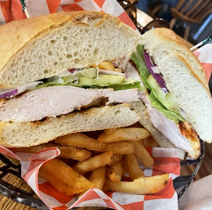 A sandwich so perfectly stacked it belongs in an architecture textbook. The chicken looks like it had a spa treatment before being nestled between those pillowy buns.
