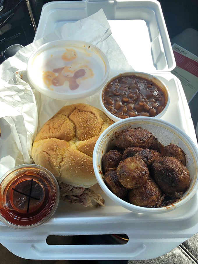 A complete barbecue sermon on a tray. Beans, cornbread, meat, and slaw—the four food groups of happiness in perfect harmony.