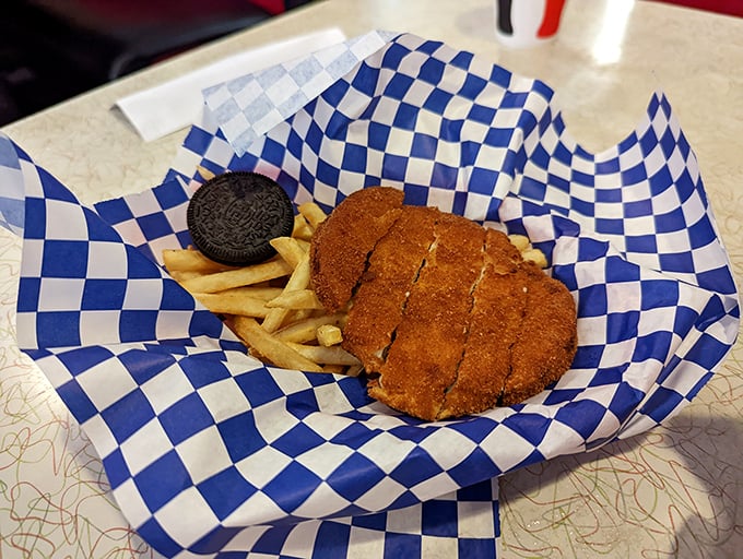 Golden-brown chicken strips nestled beside crispy fries—comfort food that whispers, "Everything's going to be okay," with every crunchy bite.