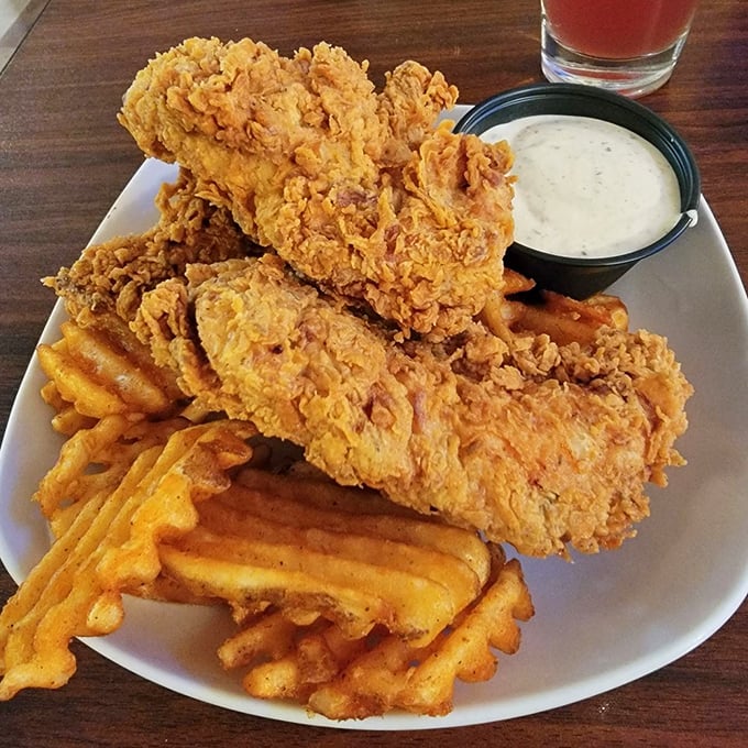 Golden-fried chicken tenders that could make the Colonel himself weep with joy, accompanied by those perfectly ridged waffle fries.