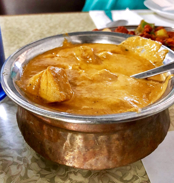 This chicken curry isn't just a dish – it's a warm, copper-bottomed hug from someone who really, really knows how to cook.