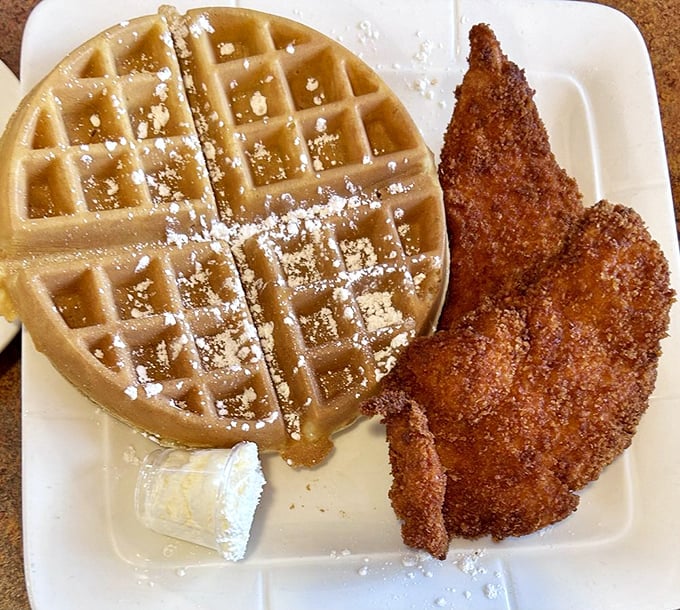 The classic chicken and waffle duo—crispy meets fluffy in a breakfast partnership that proves opposites really do attract, especially on a plate.