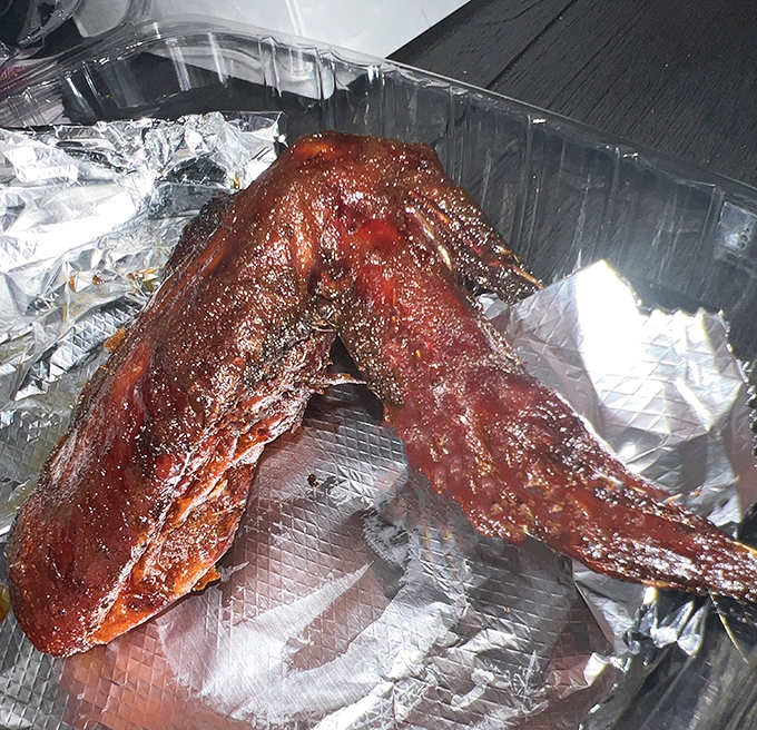 These ribs aren't falling off the bone—they're choosing to leave it because the journey was so delicious. The glossy sauce is practically winking at you.