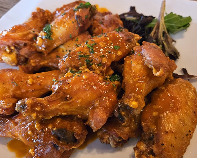 These wings aren't just cooked—they're transformed into sticky, glistening flavor bombs that demand to be devoured with absolutely zero dignity.