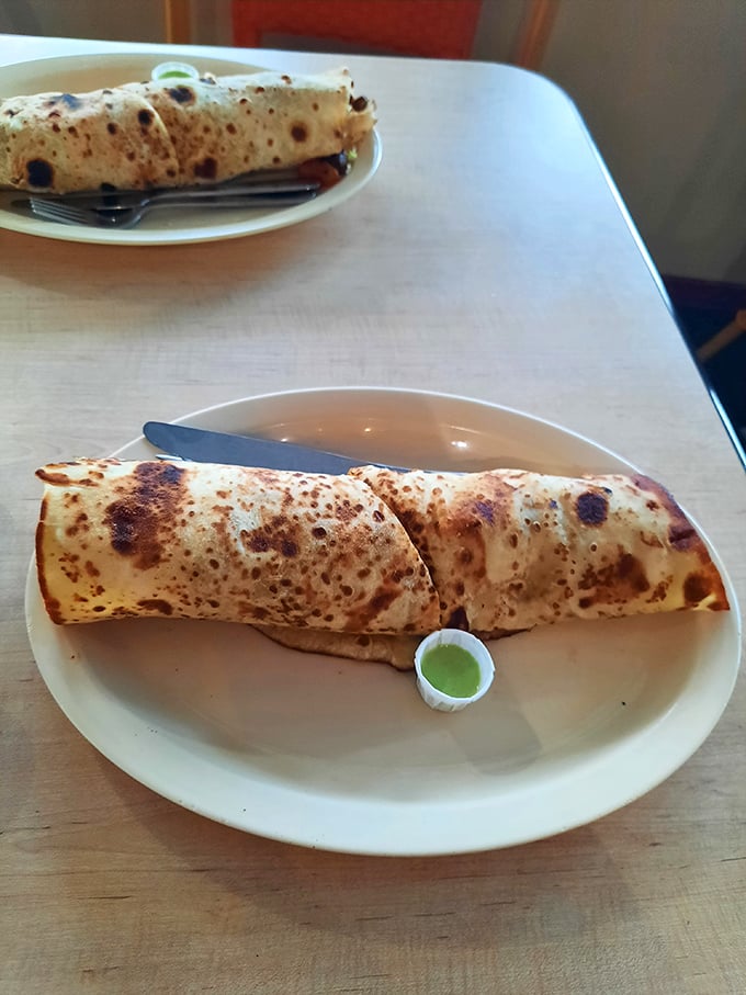 Behold the chicken wrap—where East African spices meet convenient handheld dining. That charred exterior promises flavor depths worth exploring.