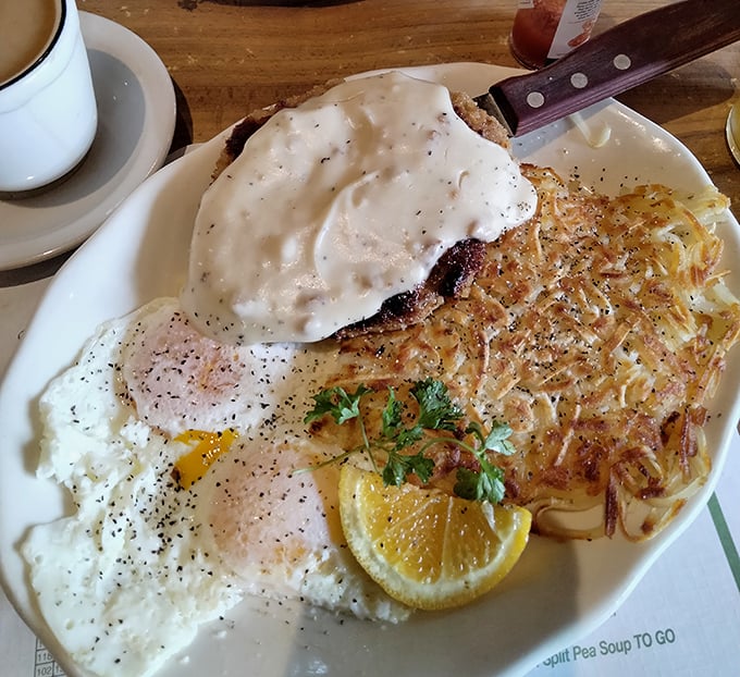 Country-fried steak smothered in gravy alongside crispy hash browns—a plate that says "you won't need to eat again until Bakersfield."