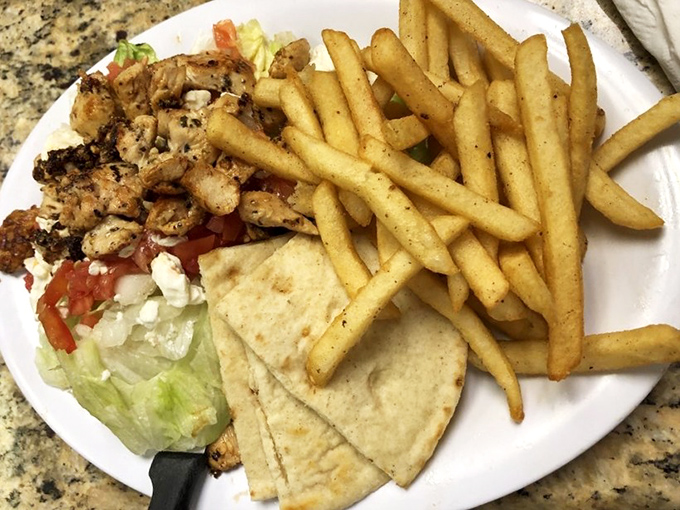 The legendary chicken gyro deconstructed—seasoned meat, fresh veggies, and warm pita triangles that make you question why you'd eat anything else.