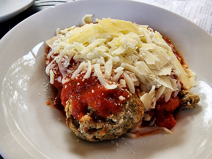 This chicken parmesan doesn't just sit on the plate—it commands attention with its golden crust, melty cheese, and marinara that tastes like summer in Tuscany.