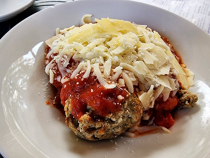 This chicken parmesan doesn't just sit on the plate—it commands attention with its golden crust, melty cheese, and marinara that tastes like summer in Tuscany.