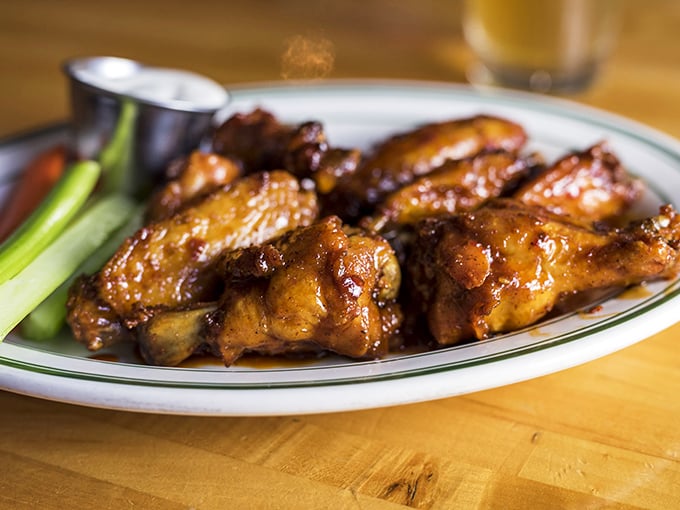 These wings glisten with sauce perfection, proving that sometimes the simplest pleasures deliver the most satisfying culinary experiences.