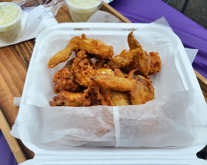 Golden-fried chicken wings that could make a vegetarian weep with temptation. Crispy outside, juicy inside—the holy grail of wing perfection.
