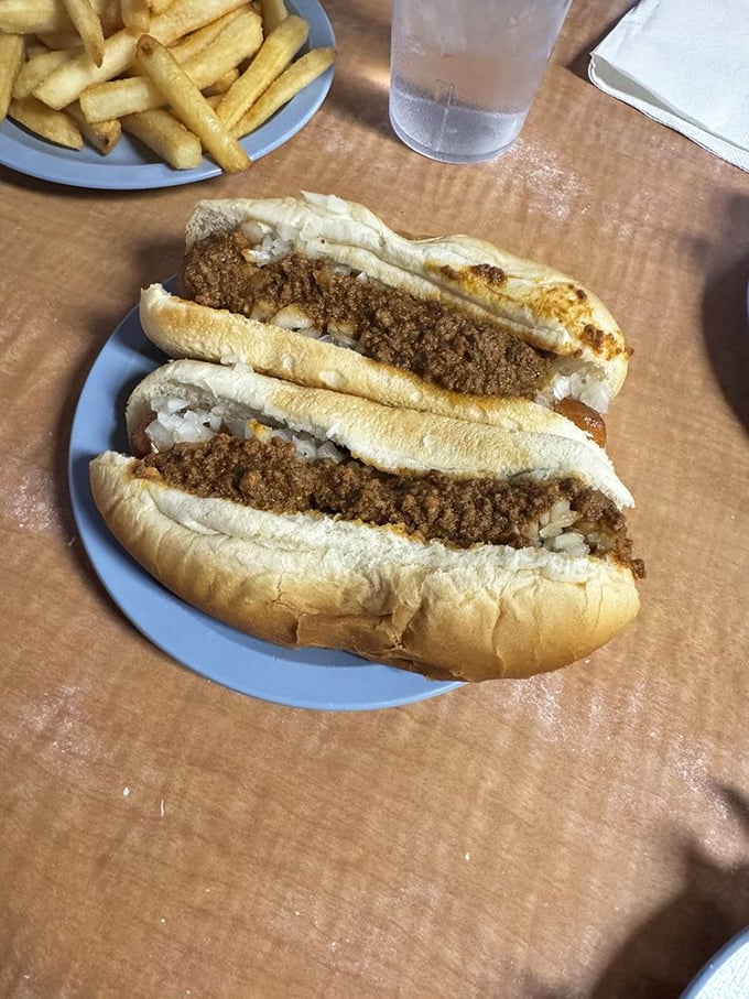 Chili dogs with diced onions—the kind that make you forget about table manners. Some meals are worth the napkin investment.