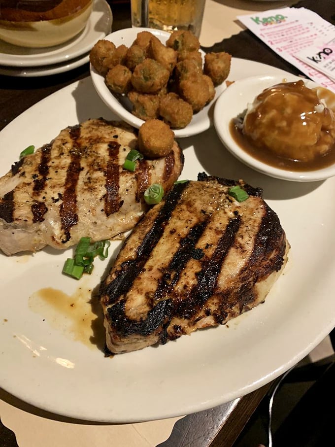 Those grill marks aren't just for show – these honey-marinated pork chops deliver a flavor punch that'll have you planning your next visit before the plate's clean.