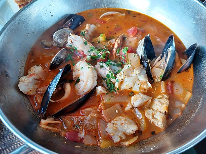 Cioppino that would make Italian fishermen proud—a tomato-based symphony of mussels, fish, and shrimp in one glorious bowl.