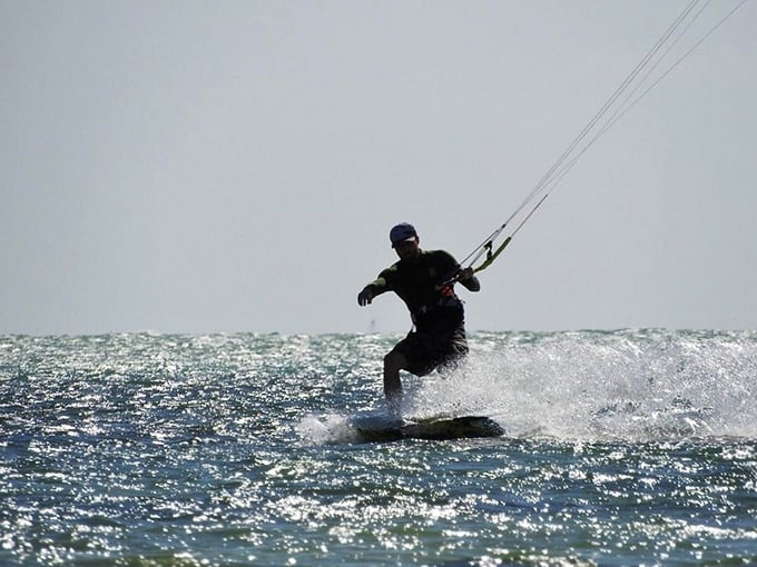 Kiteboarding at Anne's Beach—where locals get their adrenaline fix while the rest of us just try not to spill our coconut water.