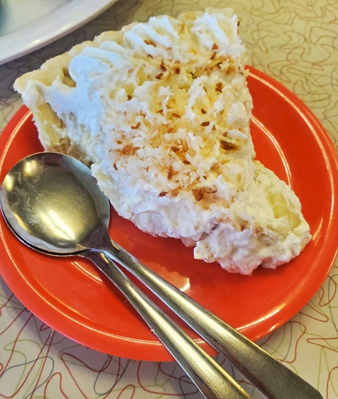 Coconut cream pie that would make your grandmother both proud and jealous. That towering meringue isn't just dessert—it's architecture with a sweet purpose.