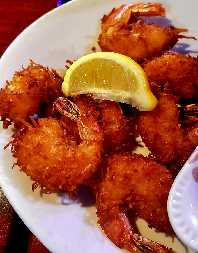 The legendary coconut shrimp—crispy, golden halos surrounding sweet Gulf shrimp. That lemon wedge isn't just garnish; it's the perfect acidic counterpoint.