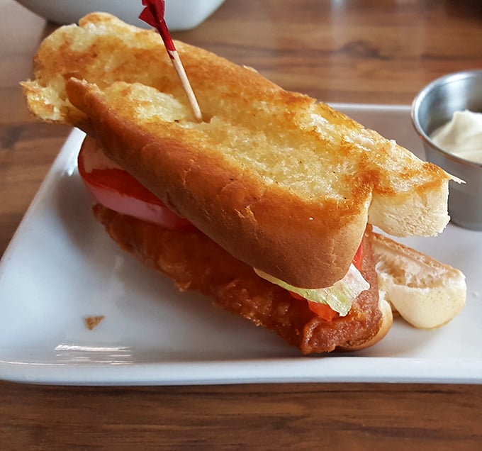 Not just a sandwich, but an engineering marvel—crispy fish, fresh toppings, and a pillowy roll that somehow manages to contain the deliciousness without surrendering to sogginess.