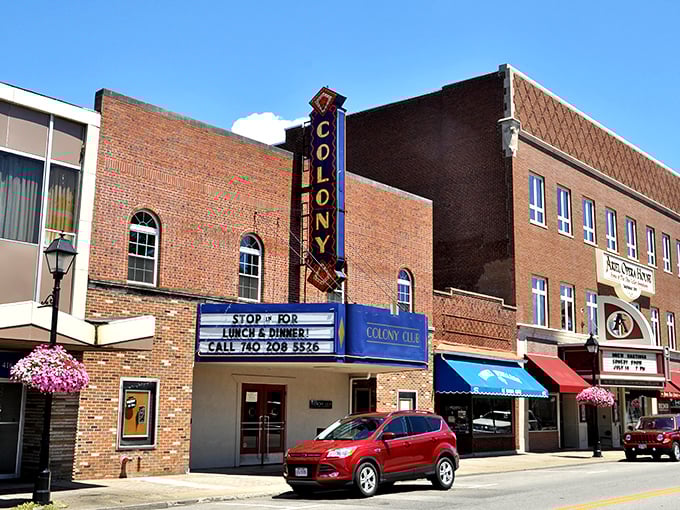 The Colony Theatre's neon sign has guided moviegoers for generations, offering entertainment without the astronomical prices of modern multiplexes.