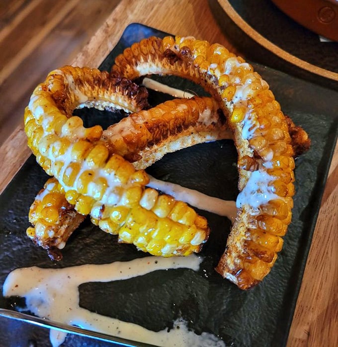 Corn reimagined as nature's candy. These caramelized corn ribs with creamy sauce prove vegetables can steal the spotlight at a steakhouse.