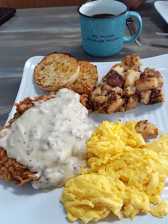 Country fried steak smothered in peppery gravy alongside fluffy scrambled eggs and home fries—the breakfast equivalent of a warm hug from your favorite aunt.