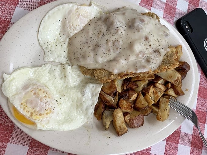 Country fried steak with eggs and home fries – the breakfast trinity that's converted more morning skeptics than Sunday sermons. That gravy deserves its own zip code.