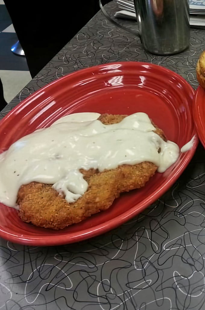 Country fried steak swimming in creamy gravy—the kind of dish that makes you want to hug the cook and take a nap immediately after.
