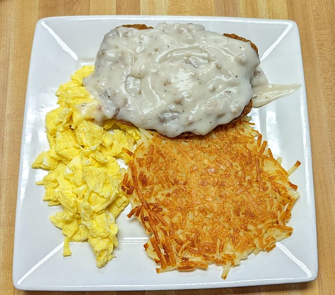Fluffy scrambled eggs meet crispy hash browns in a breakfast symphony that hits every perfect note.