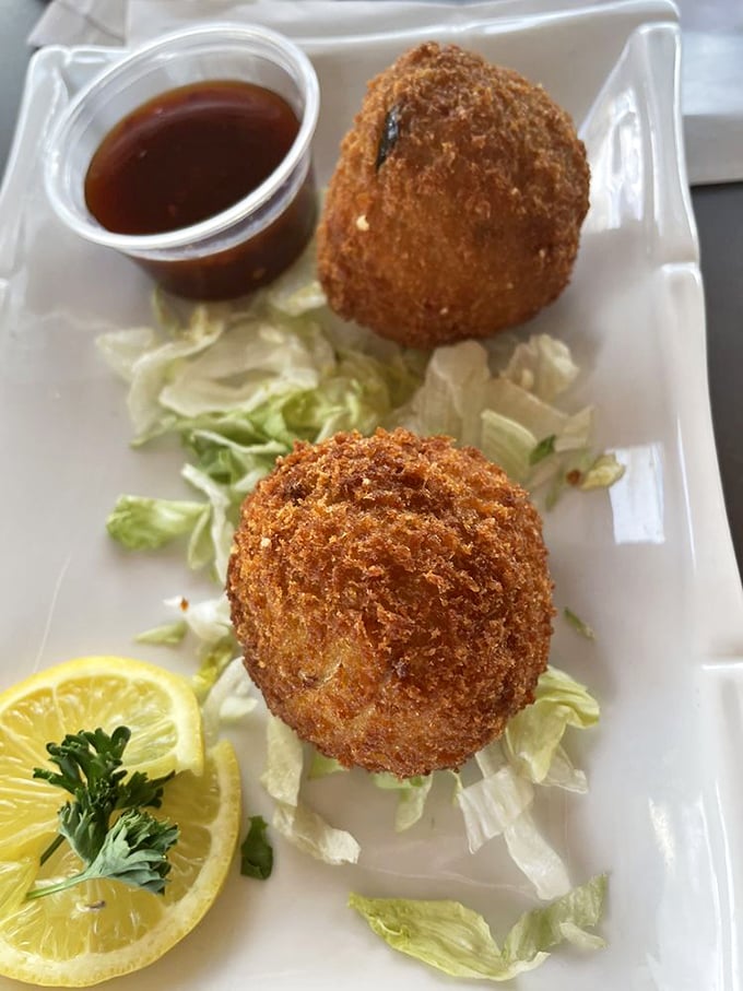 Crab balls that could convert any seafood skeptic—crispy on the outside, tender within, and served with the kind of sauce that makes you consider drinking it straight.