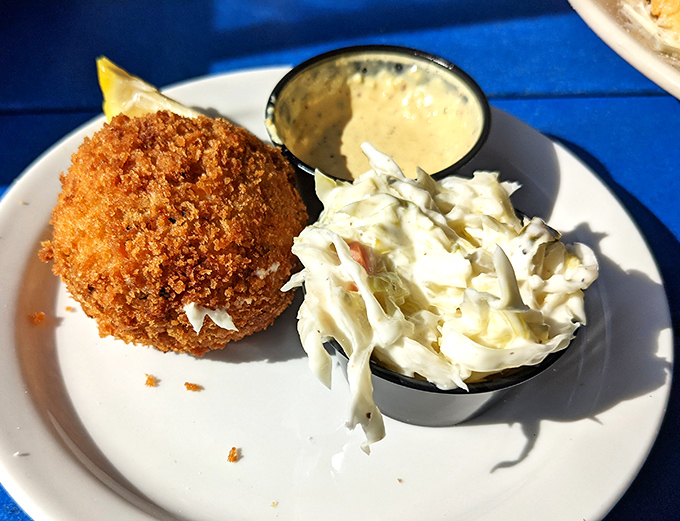 The golden-brown crab cake looks like it's auditioning for a seafood calendar – crispy exterior giving way to sweet crabmeat with minimal filler getting in the way.