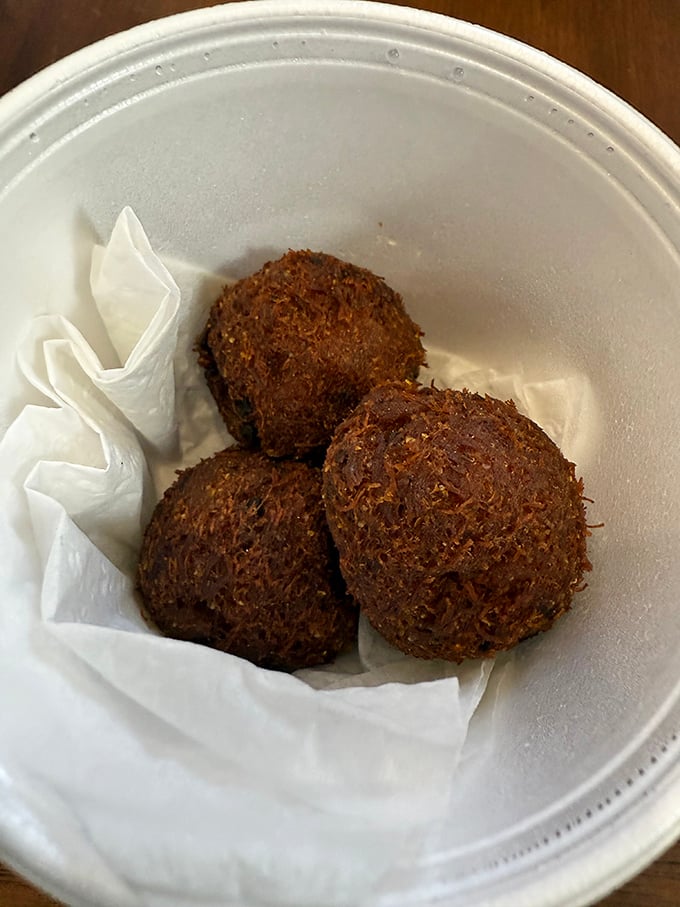 These crab balls aren't just appetizers—they're golden-brown spheres of oceanic delight that make you wonder why you'd ever order anything else.