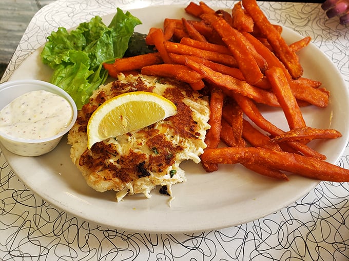 The star of the show—a golden-brown crab cake that's more crab than cake, served with sweet potato fries that could steal the spotlight anywhere else.
