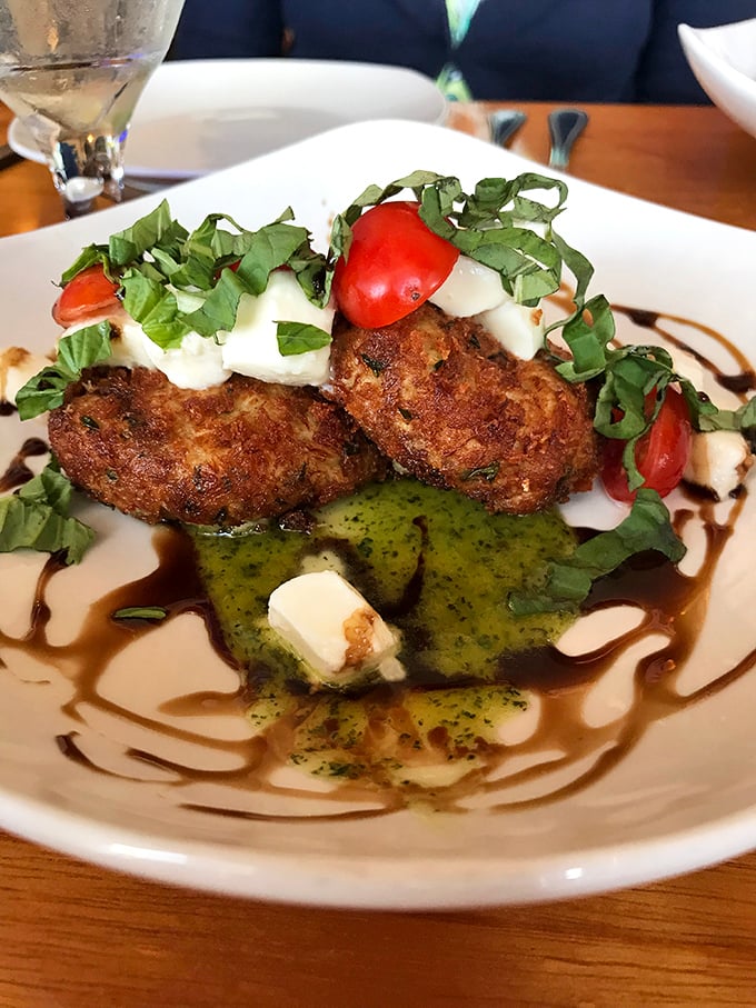 These crab cakes aren't hiding behind fillers—they're proudly showcasing their crabby personality with a drizzle of sauce that means business.