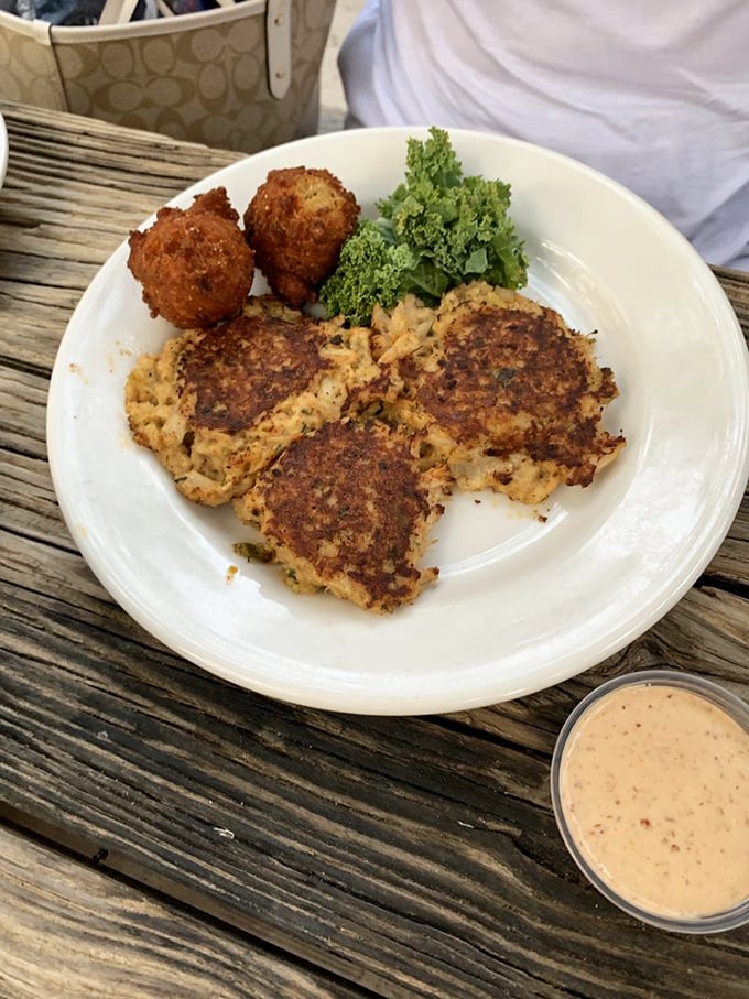 Crab cakes as they should be—mostly crab, barely bound, perfectly browned, and served with a sauce that deserves its own fan club.