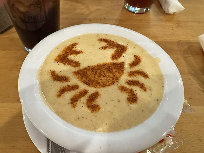 The cream of crab soup arrives with an artistic Old Bay crab silhouette—culinary skill meets Instagram-worthy presentation.