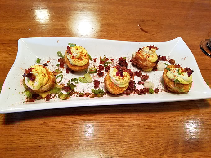 Deviled eggs got dressed up for a night on the town, trading grandma's paprika for crispy coatings and fancy toppings – retro comfort food with a PhD.