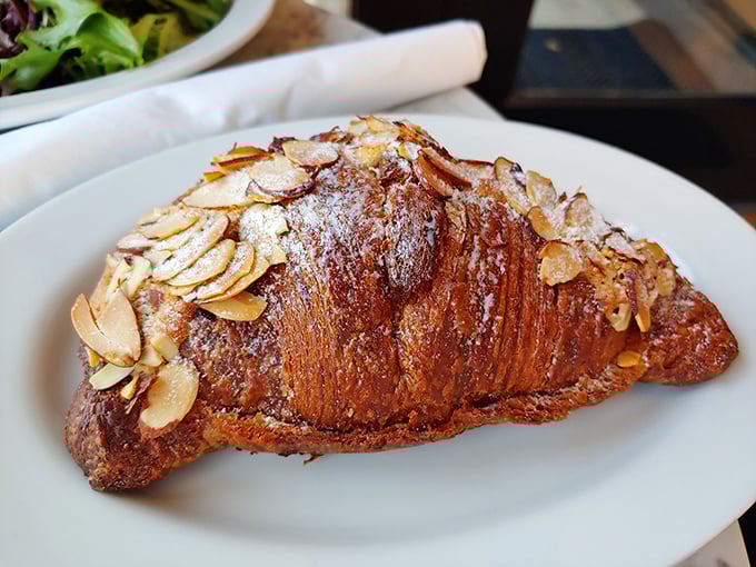 This isn't just an almond croissant—it's what other almond croissants dream of becoming when they grow up, golden and flaky with a generous crown of toasted almonds.