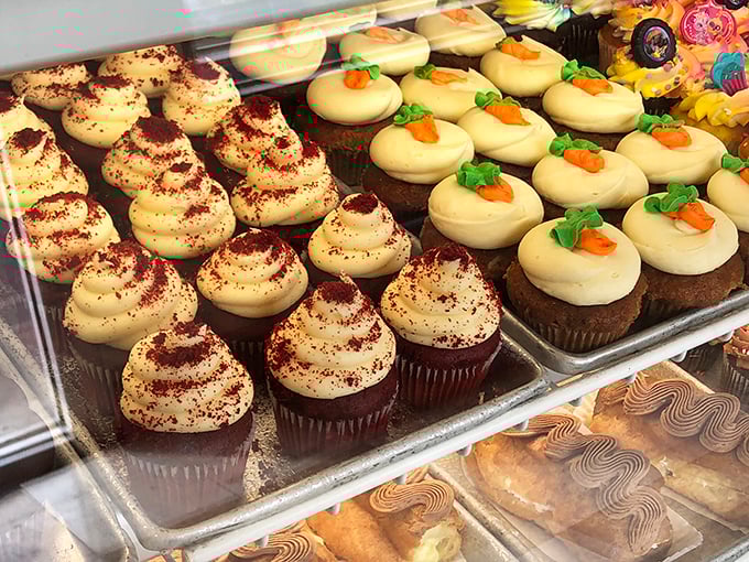 Red velvet cupcakes with perfect swirls of cream cheese frosting alongside carrot cake minis—these aren't just desserts, they're edible time machines to childhood.