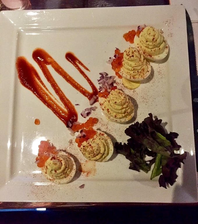 Deviled eggs elevated to art form – these aren't your aunt's potluck contribution, but a sophisticated appetizer with elegant piping and thoughtful garnishes.