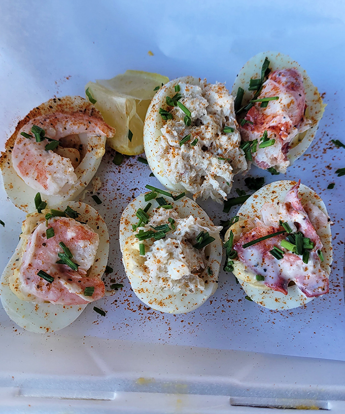 These deviled eggs aren't having an identity crisis—they've confidently embraced their seafood destiny with lobster, crab, and shrimp toppings.