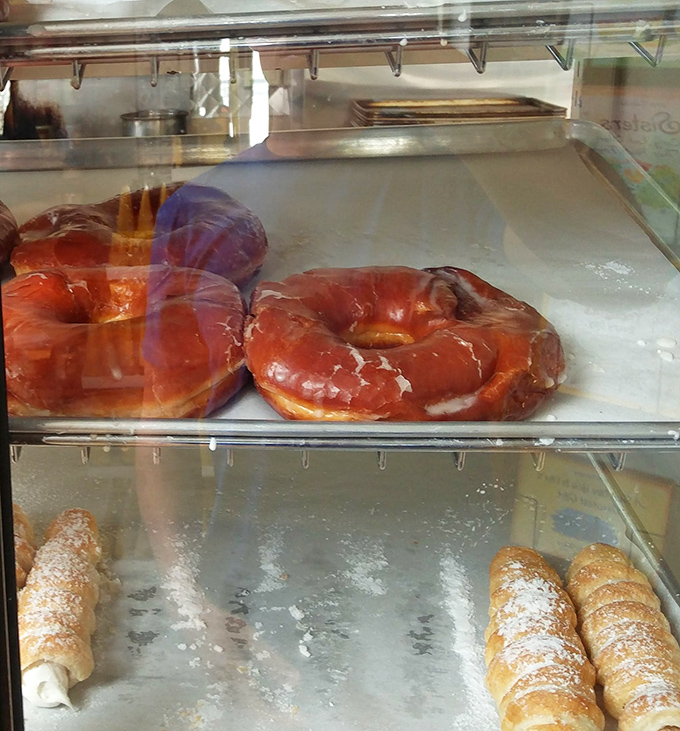 Glazed donuts that glisten like jewels under glass. The ancient Romans built empires, but they never created anything this perfect.