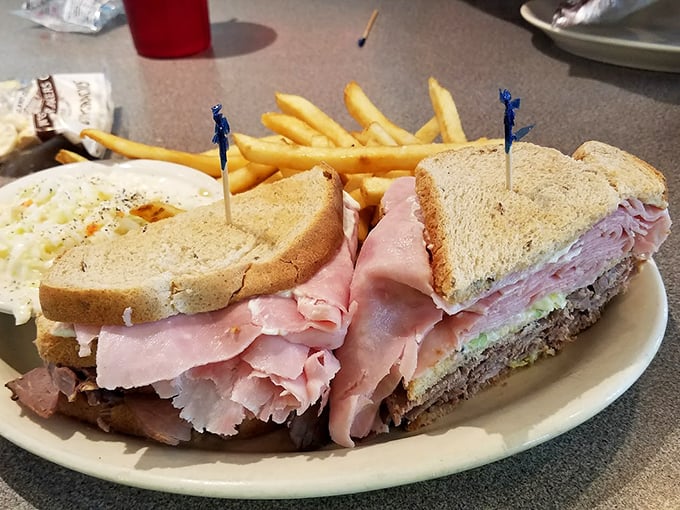 This isn't just a sandwich; it's an architectural marvel of ham, turkey, and fixings that requires both hands and zero shame.