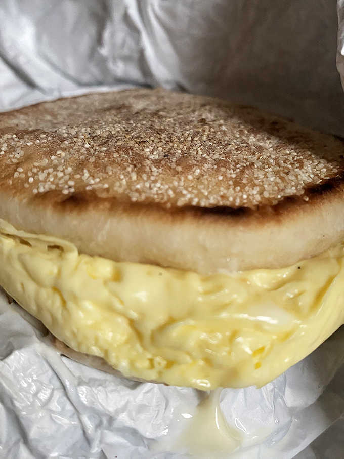 Behold the sandwich that launched a thousand morning commutes – a pillowy English muffin embracing melted cheese and egg with dignified simplicity.