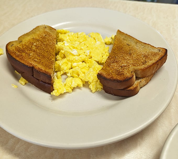 Perfectly scrambled eggs with toast that's achieved that magical golden-brown state. Breakfast simplicity that reminds us why the classics never go out of style.