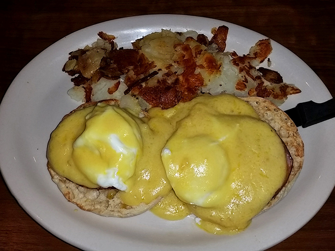 Eggs Benedict: where breakfast meets luxury. Those golden yolks are about to stage a delicious jailbreak across English muffin terrain.
