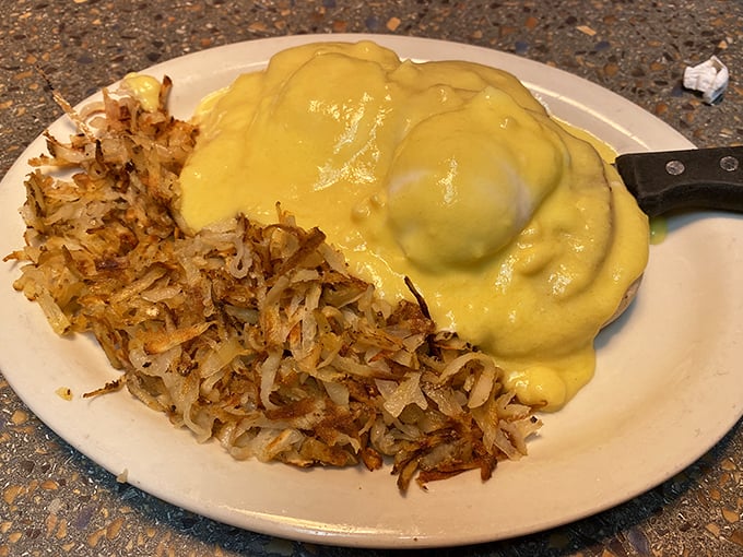 Home fries crisped to golden perfection alongside eggs draped in hollandaise—a breakfast that makes morning people out of night owls.