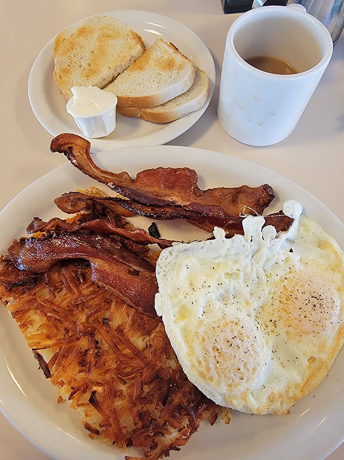 Sunny-side up eggs, perfectly crisped bacon, and hash browns that crackle with each forkful—breakfast's holy trinity.