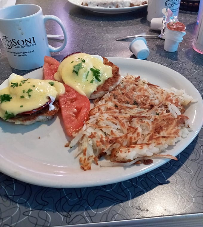 These eggs Benedict aren't just breakfast, they're architecture—perfectly poached eggs balancing on Canadian bacon with hollandaise cascading like a yellow waterfall.