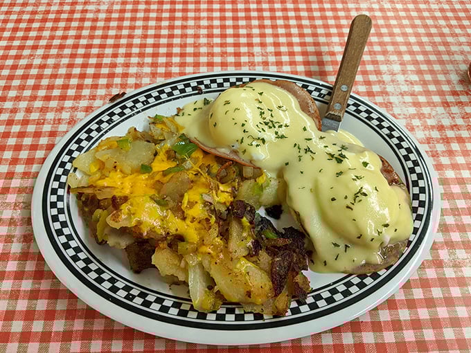 Eggs Benedict done right – creamy hollandaise cascading over poached perfection like edible sunshine on a plate.